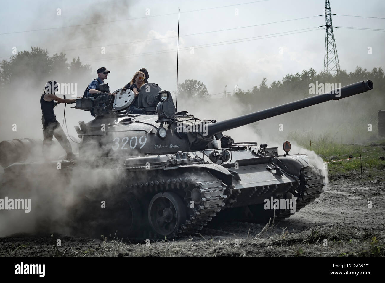 Fast ride in dust of the Soviet T-55 tank with spectators during ...