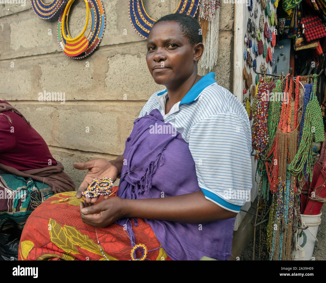 Portrait of a woman showing her beading at the Maasai Market, central ...