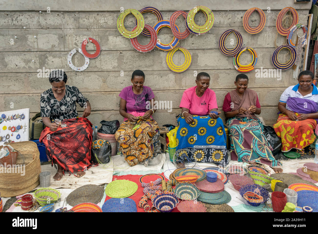 Women making bead work at the Maasai Market, central Arusha, Tanzania ...