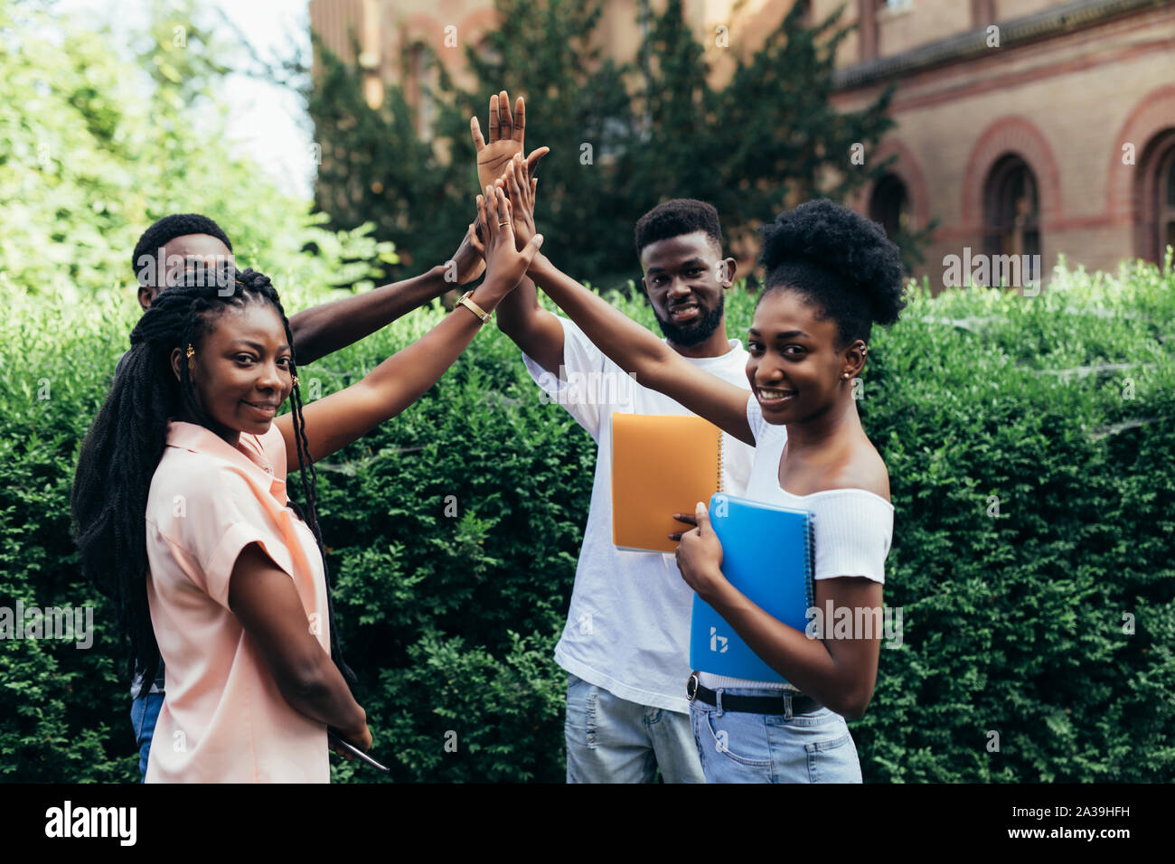 International group of young students giving high five celebrating ...