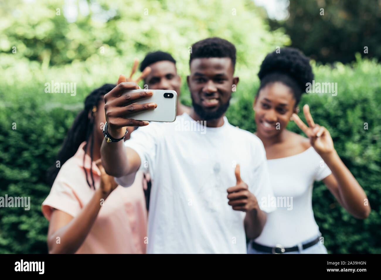 Group of students taking self-portrait with camera phone Stock Photo ...