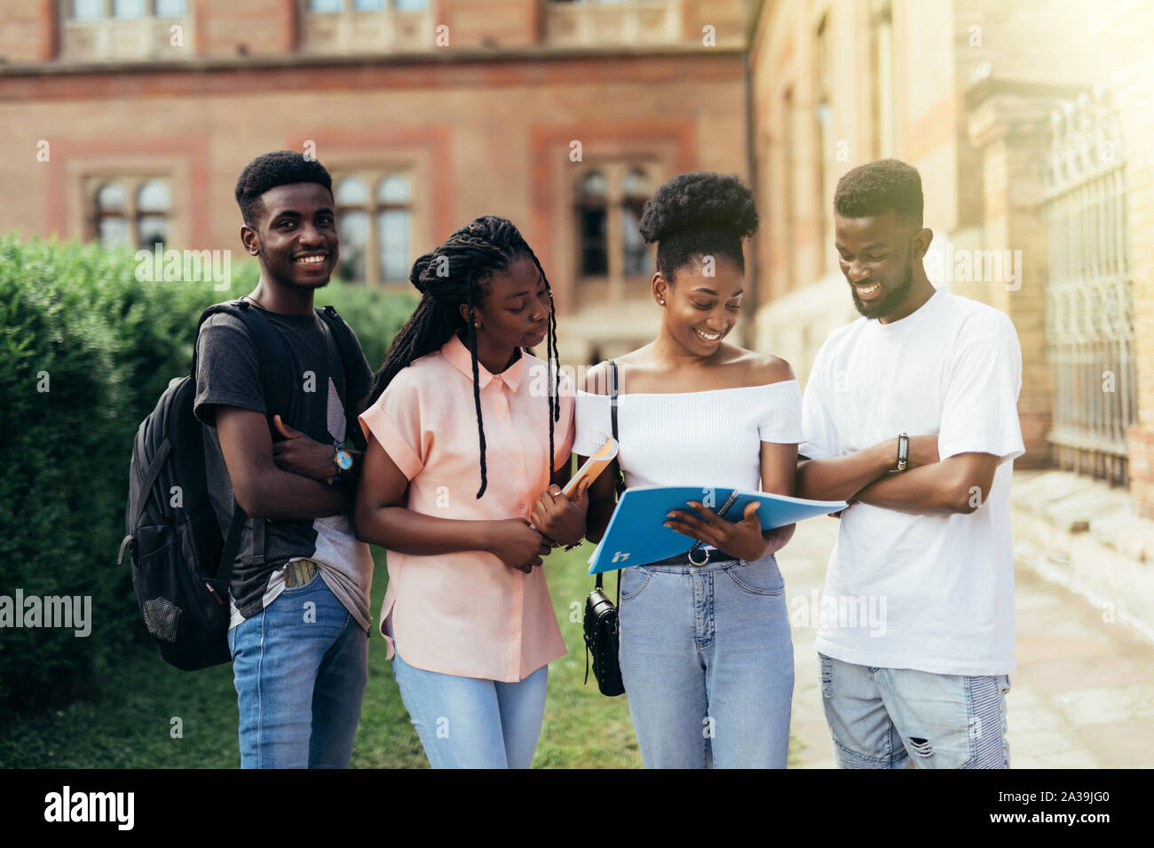 Pretty four students are relaxing after classes Stock Photo - Alamy