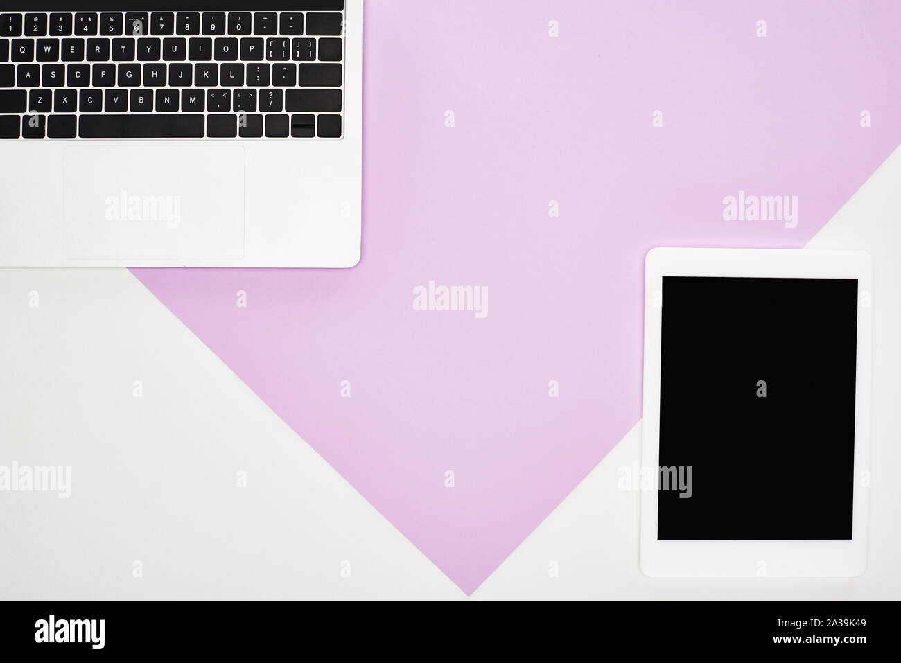 flat lay with laptop, digital tablet with blank screen on violet and ...