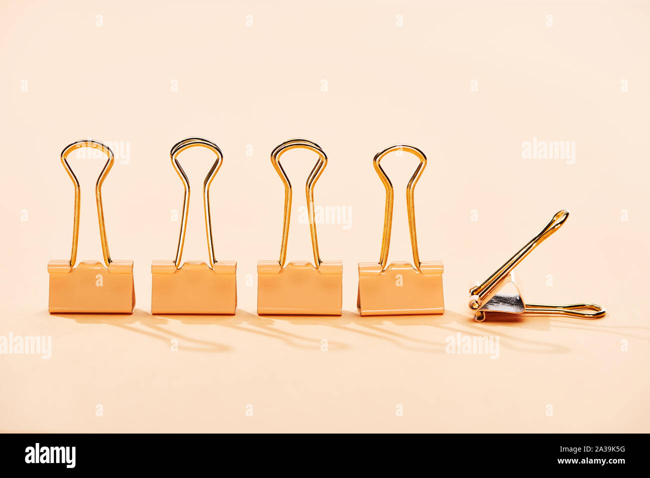 row of paper clips on beige background with copy space Stock Photo - Alamy