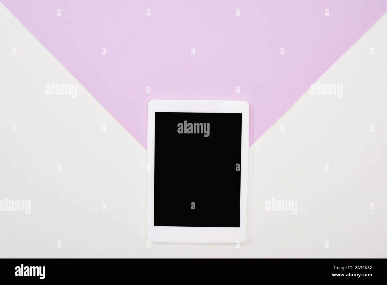 top view of digital tablet with blank screen on violet and white ...