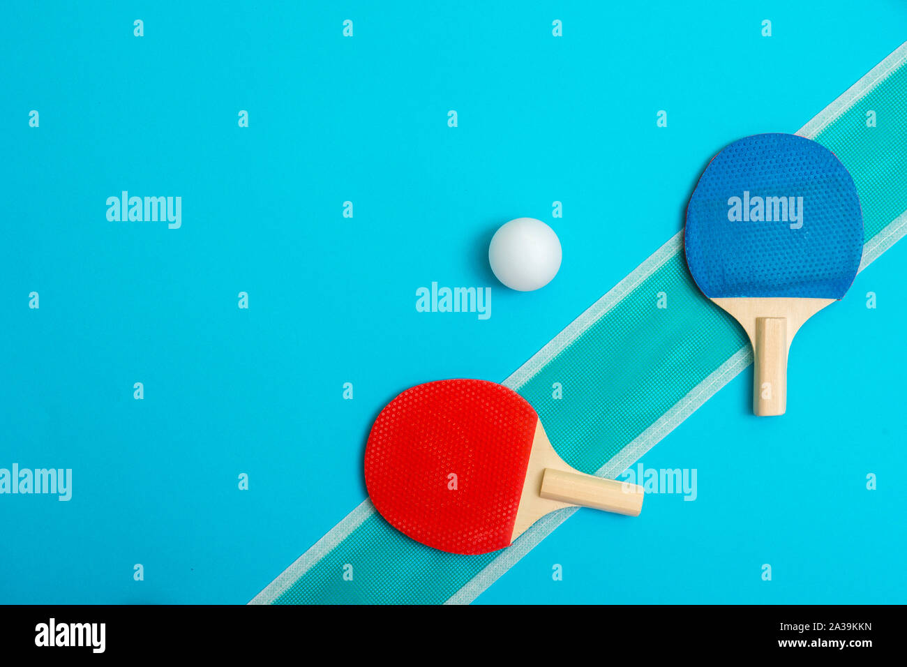 Two rackets for playing table tennis on blue background Stock Photo - Alamy