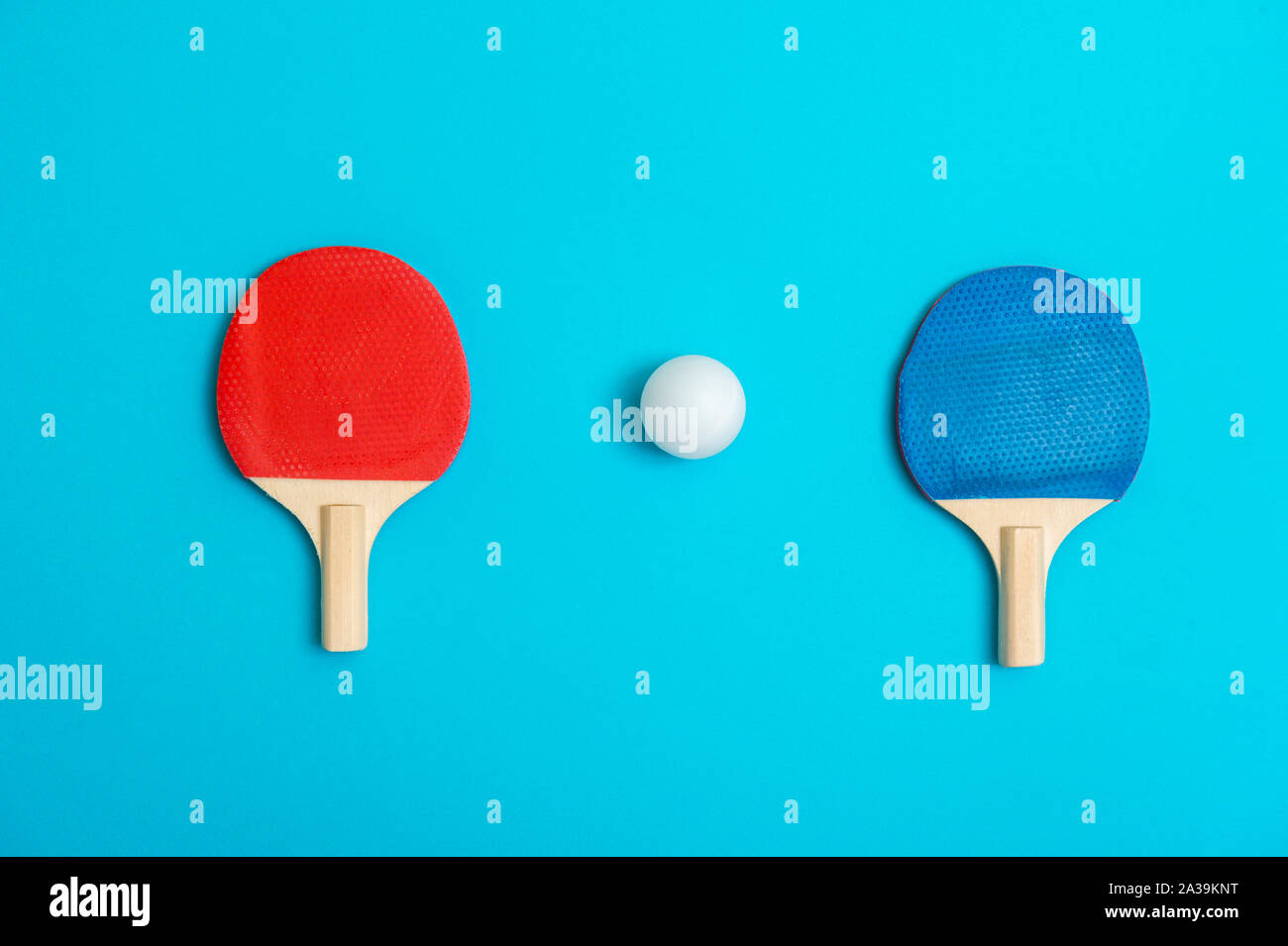 Two rackets for playing table tennis on blue background Stock Photo - Alamy