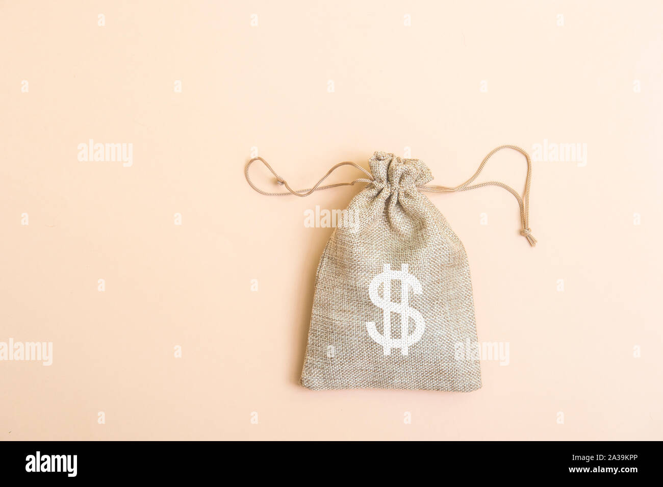 Money bag on light beige natural background Stock Photo - Alamy