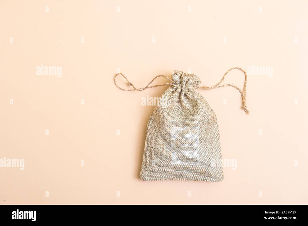 Money bag on light beige natural background Stock Photo - Alamy