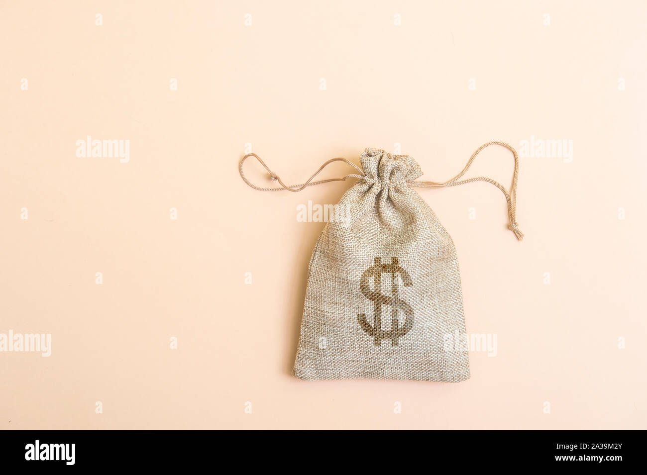 Money bag on light beige natural background Stock Photo - Alamy