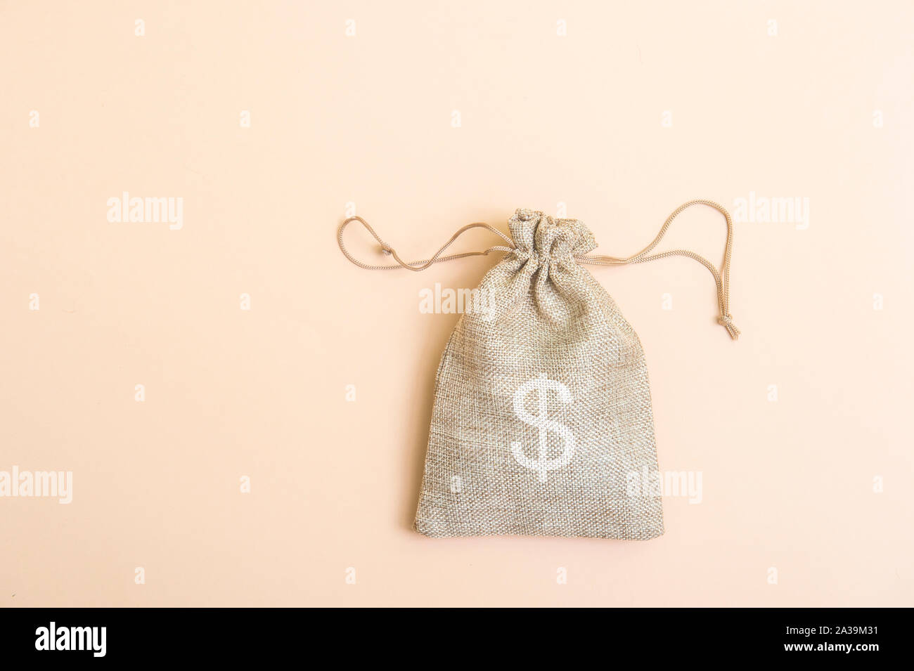 Money bag on light beige natural background Stock Photo - Alamy