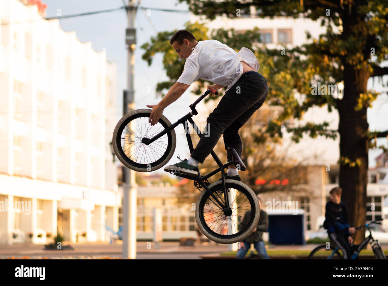 The guy performs a stunt on BMX, jumping up, and touches the front ...