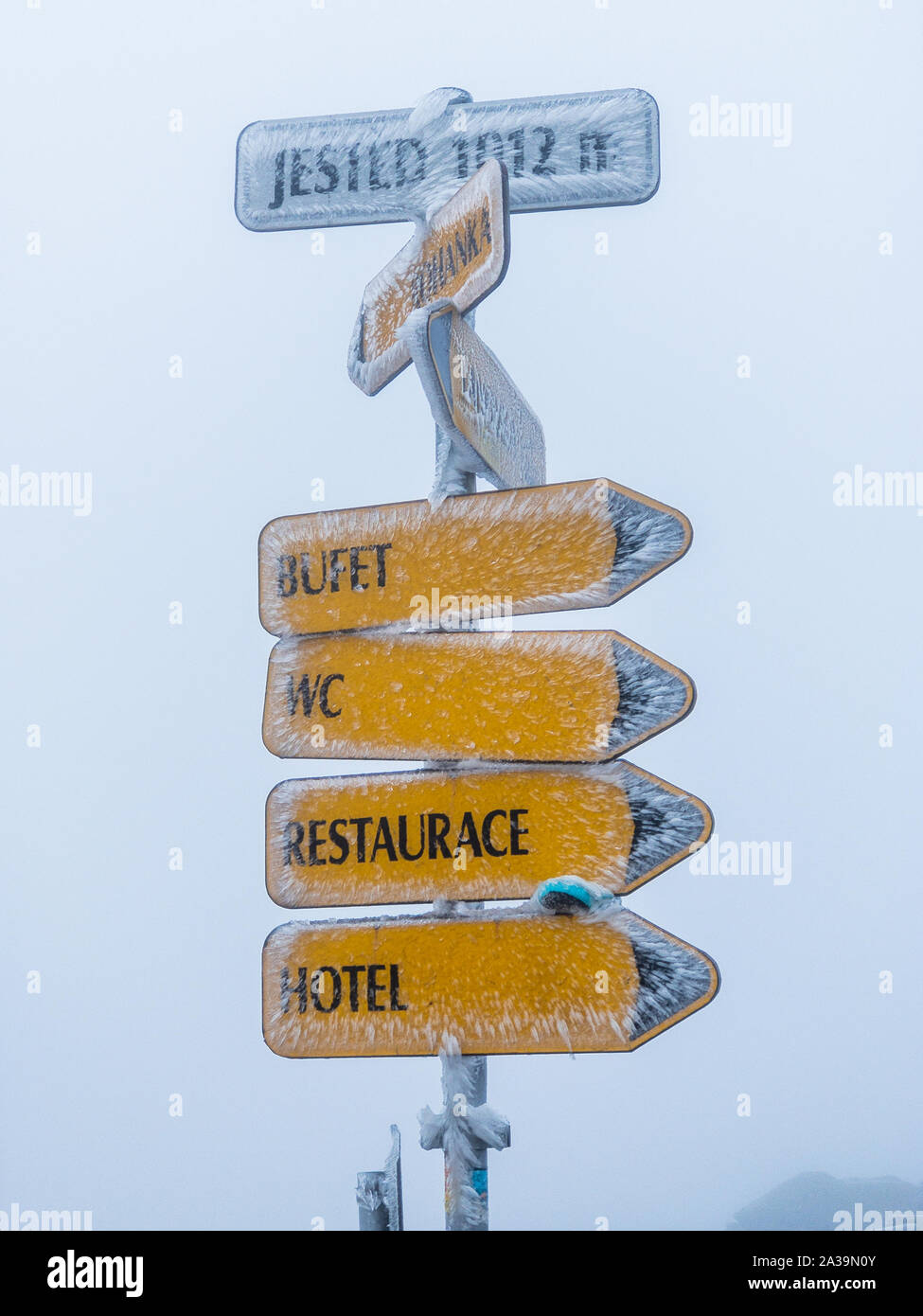 Hiking pointer covered by ice and snow Stock Photo - Alamy