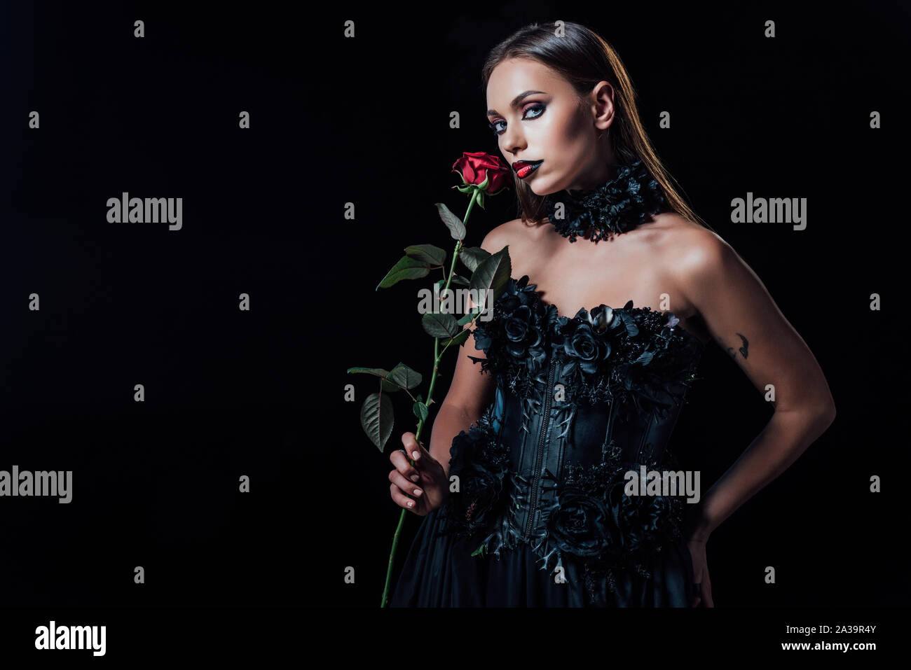 Gothic girl holding black rose hi-res stock photography and images - Alamy