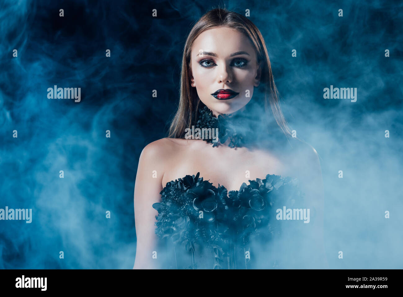 scary vampire girl in black gothic dress on black background with smoke ...