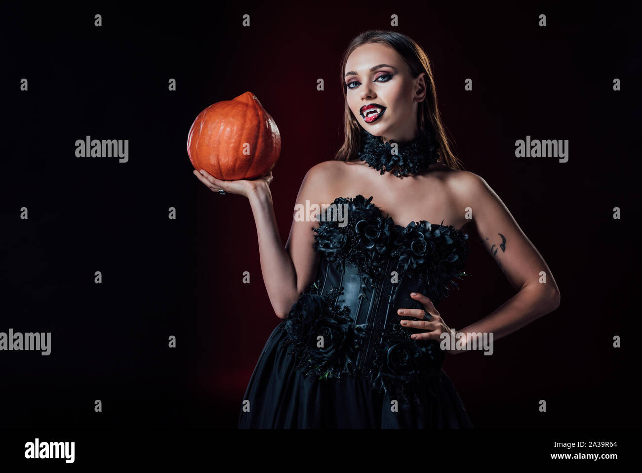Scary Vampire Girl With Fangs In Black Gothic Dress Holding Halloween