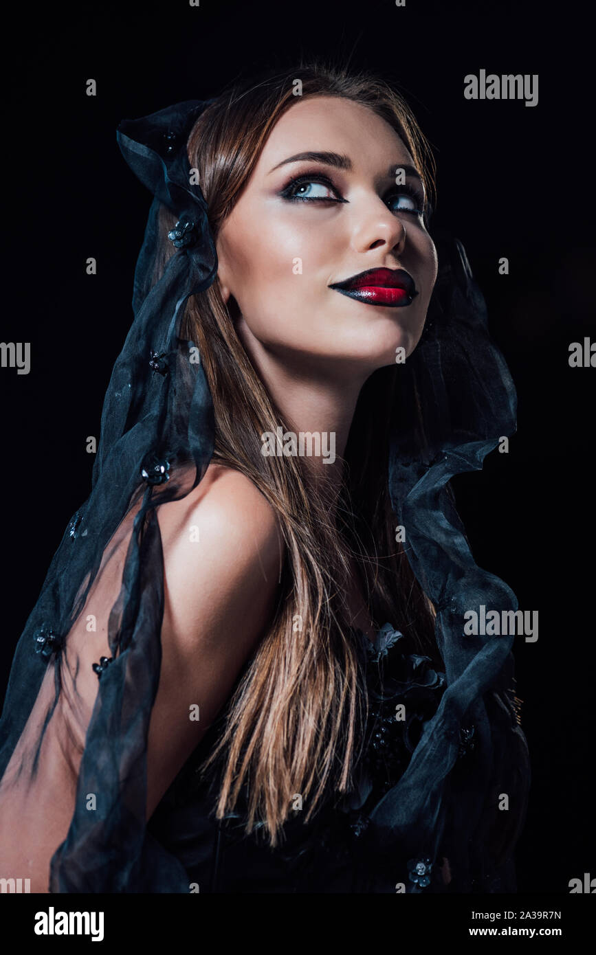 smiling vampire girl in black gothic dress and veil isolated on black ...
