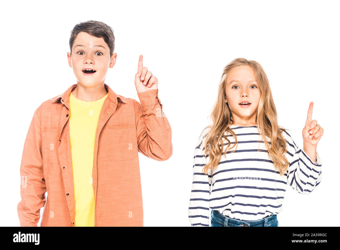 front view of two surprised kids showing idea signs isolated on white ...