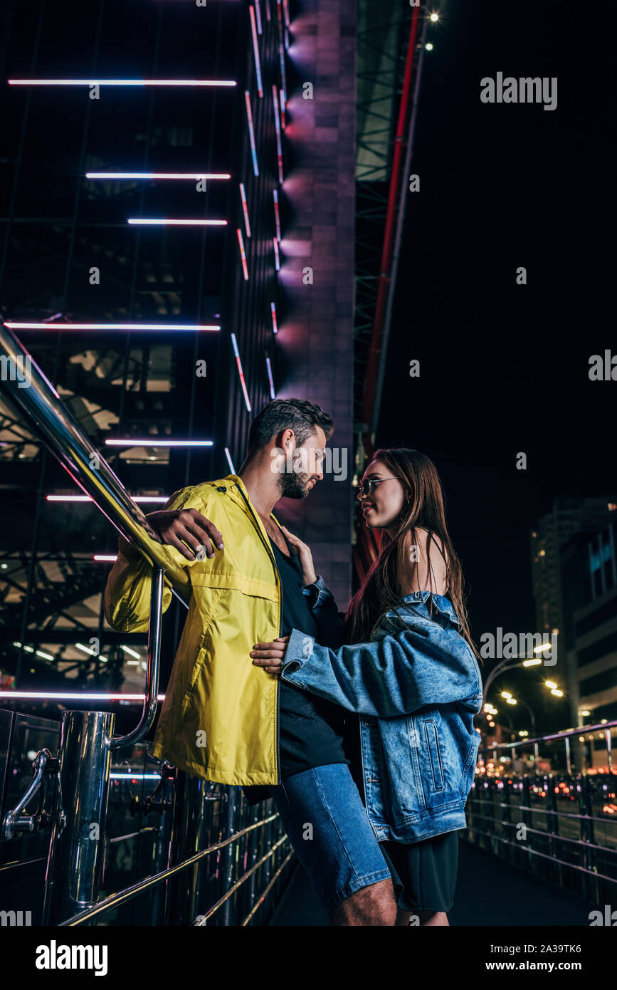 side view of handsome boyfriend and attractive girlfriend in denim ...
