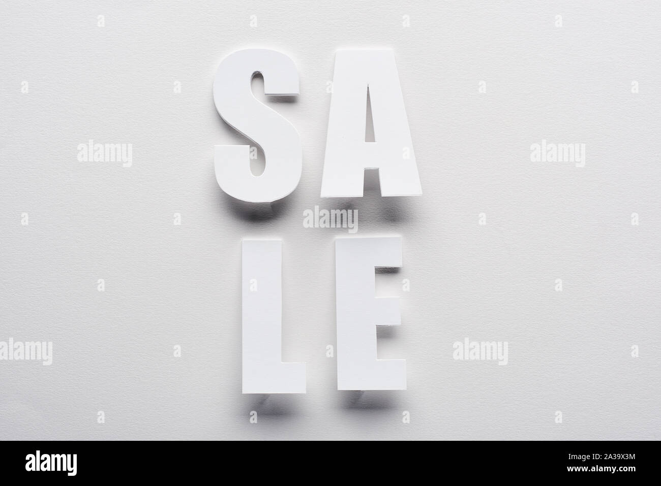 top view of white sale lettering on white background Stock Photo - Alamy