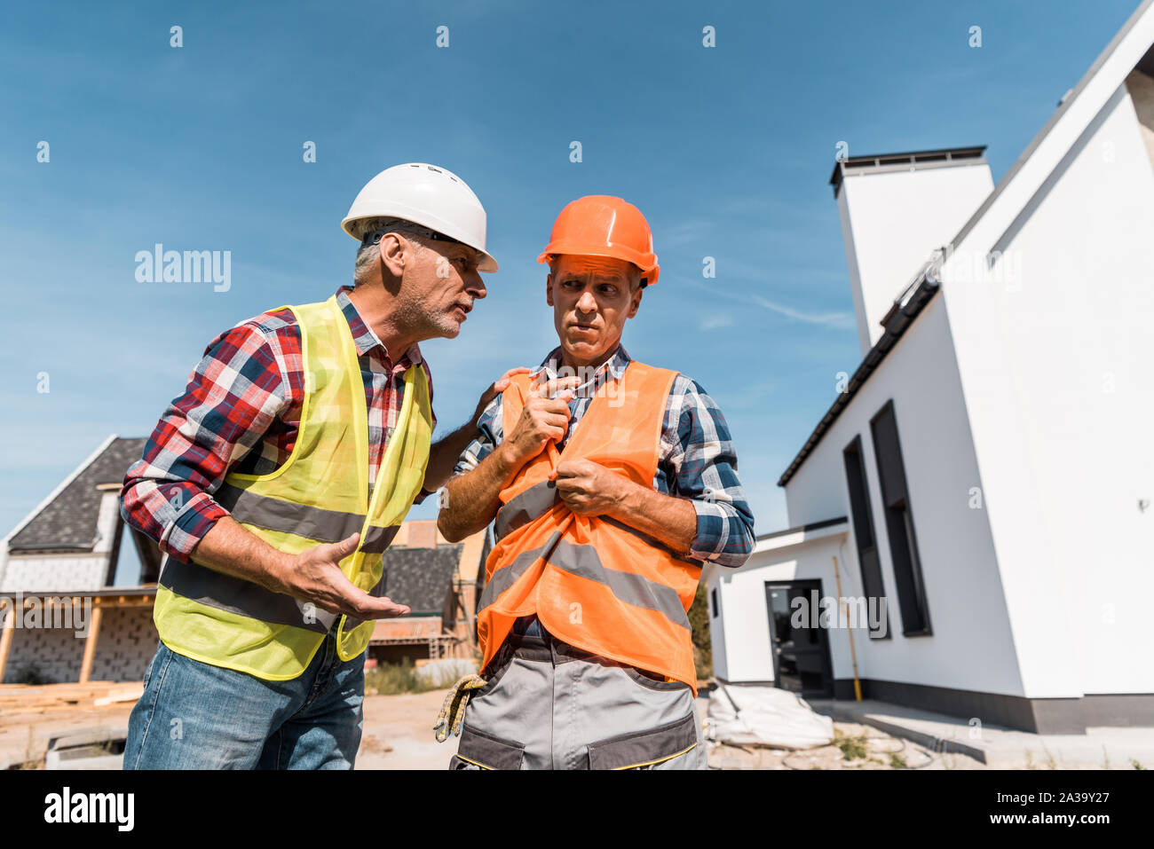 Men in helmets standing construction hi-res stock photography and ...