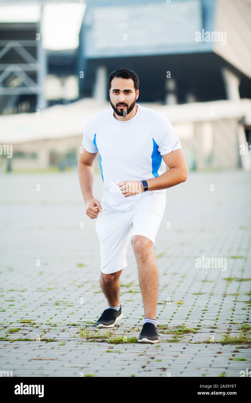 Fitness. Young man running in urban environment Stock Photo - Alamy