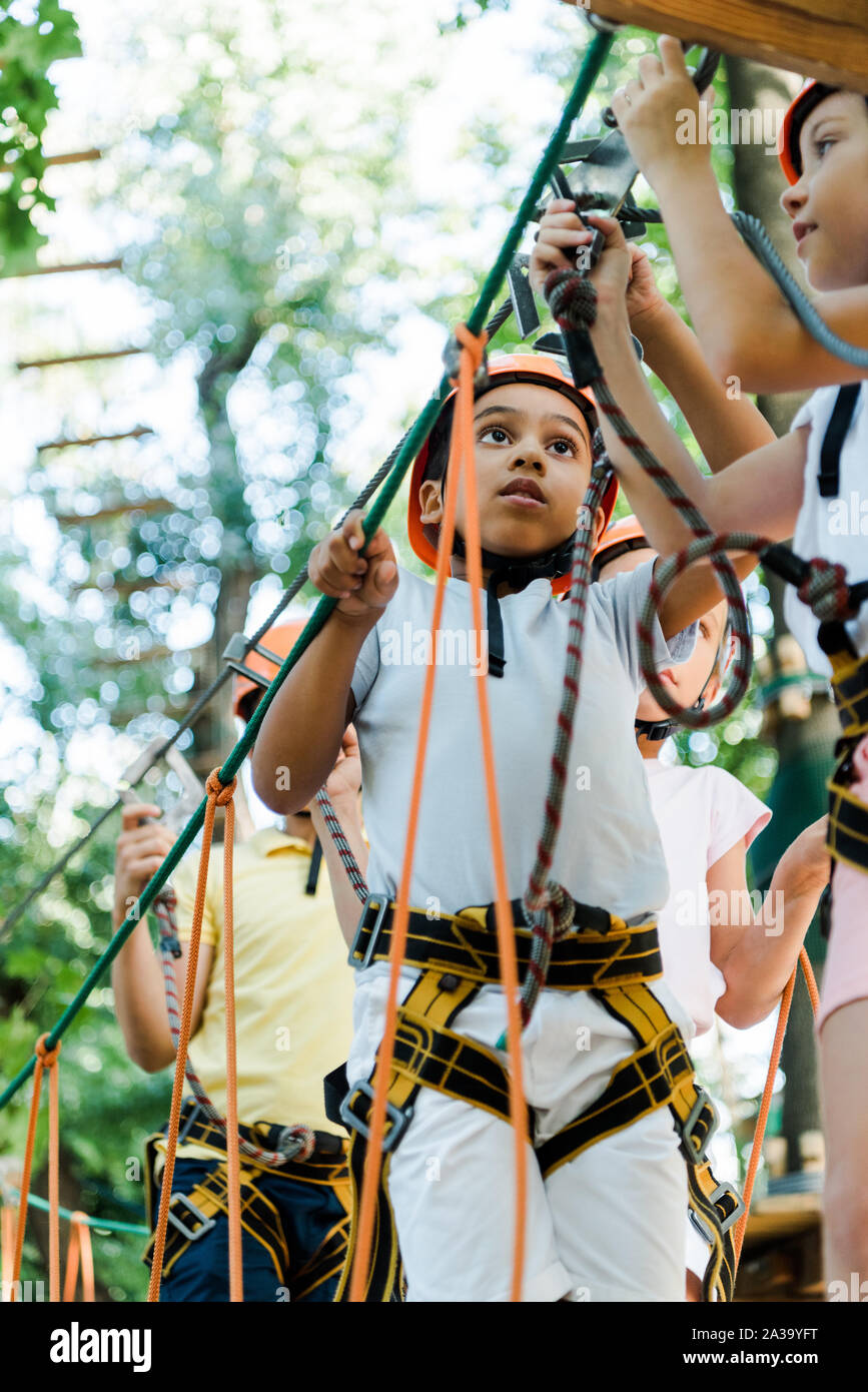 selective focus of cute multicultural kids with height equipment ...
