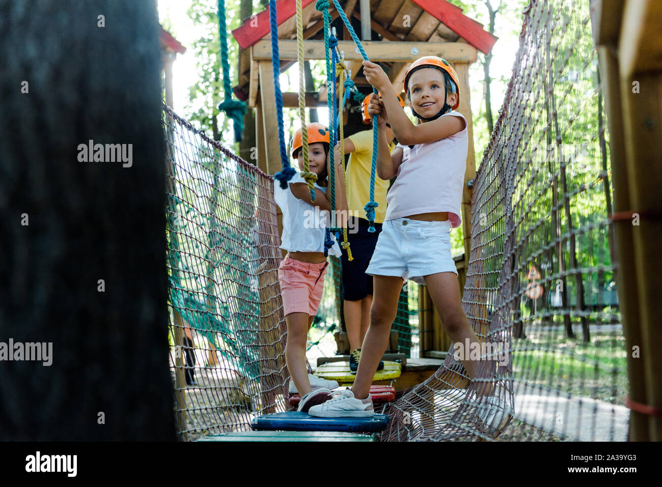 selective focus of cute kids near boy in adventure park outside Stock ...