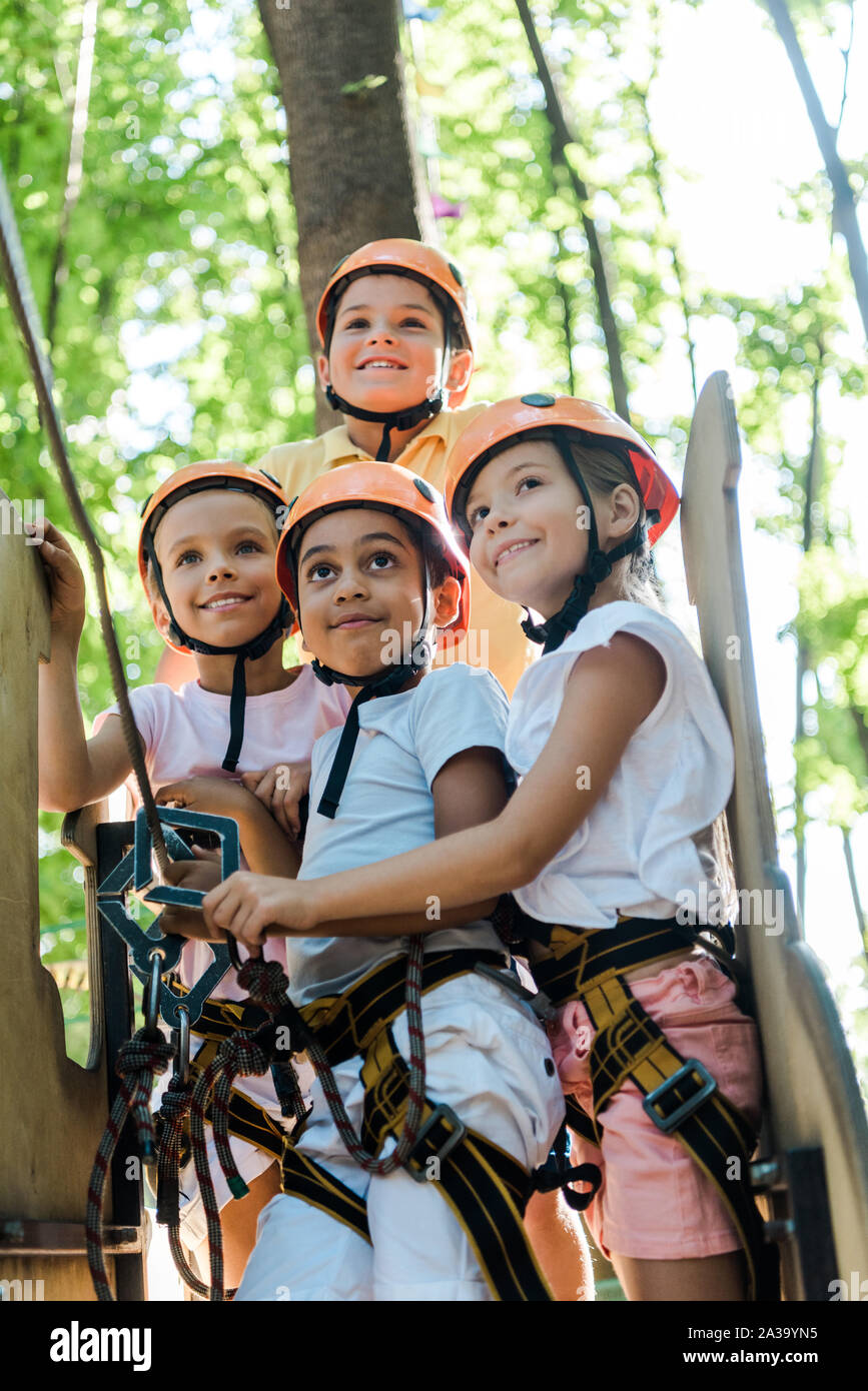positive multicultural kids looking up in adventure park outside Stock ...