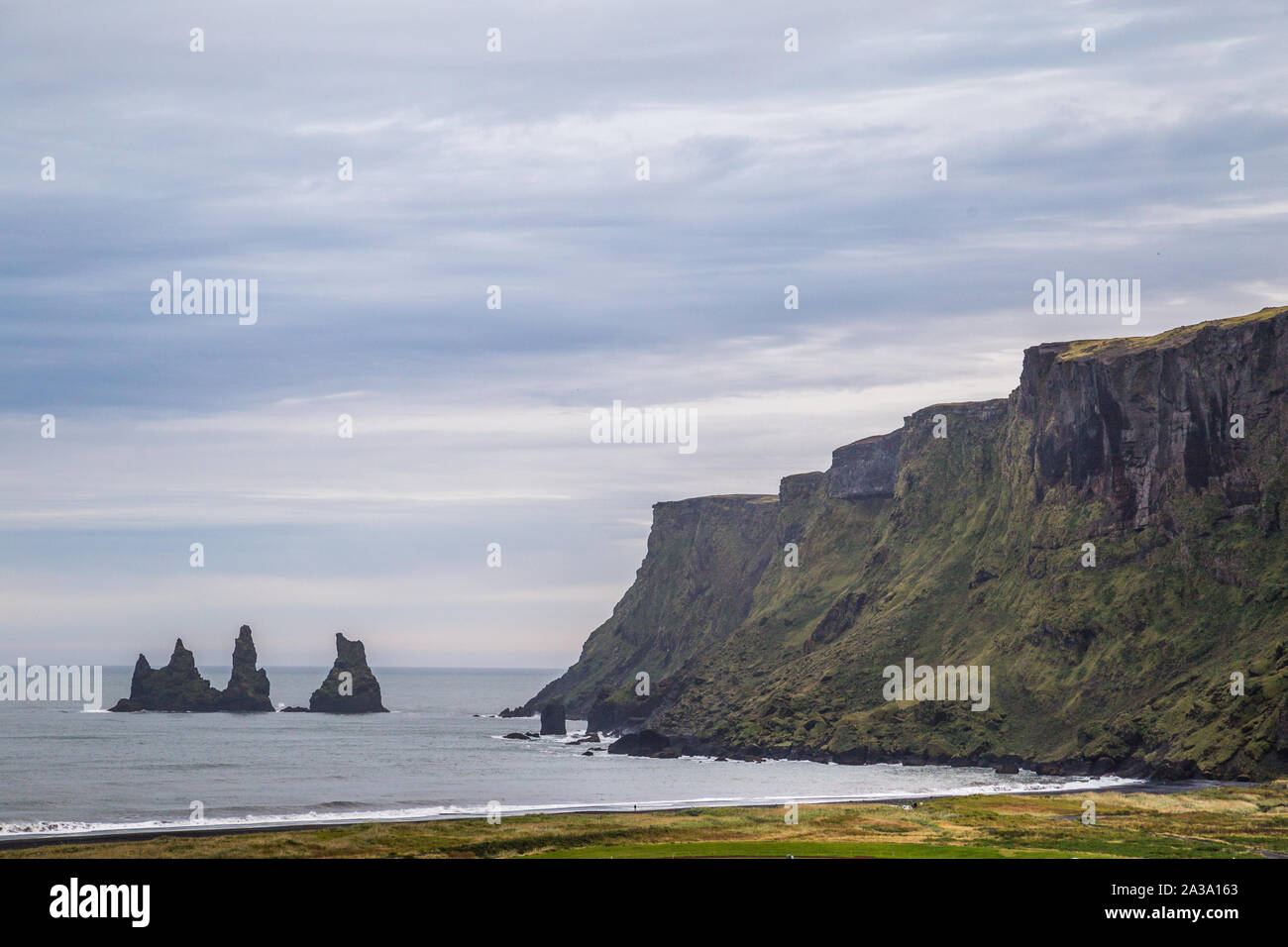 Scenic seafront village of Vik overlooks basalt columns, rock ...