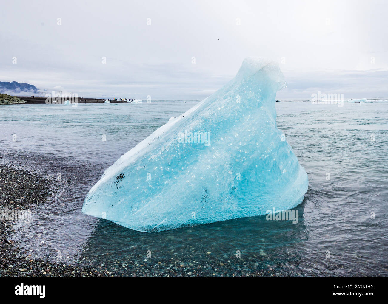 Iceberg on the shore of black sand covered Diamond Beach in Iceland ...