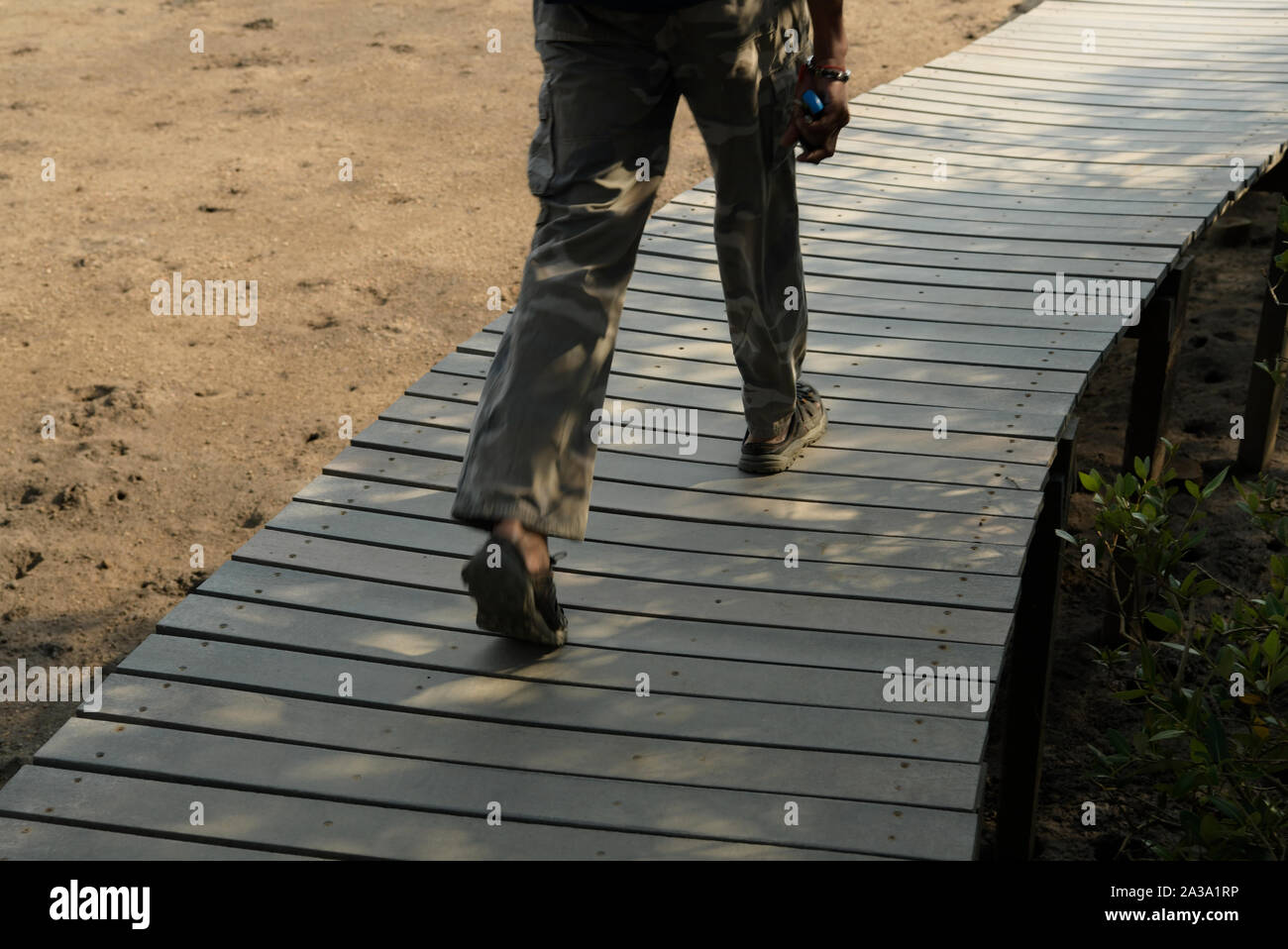 Moving legs of single adult man walking on promenade, movement, action ...