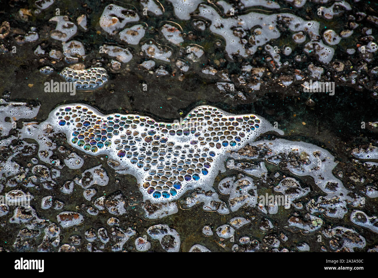 close up of iridescent soap bubble pattern on asphalt Stock Photo - Alamy