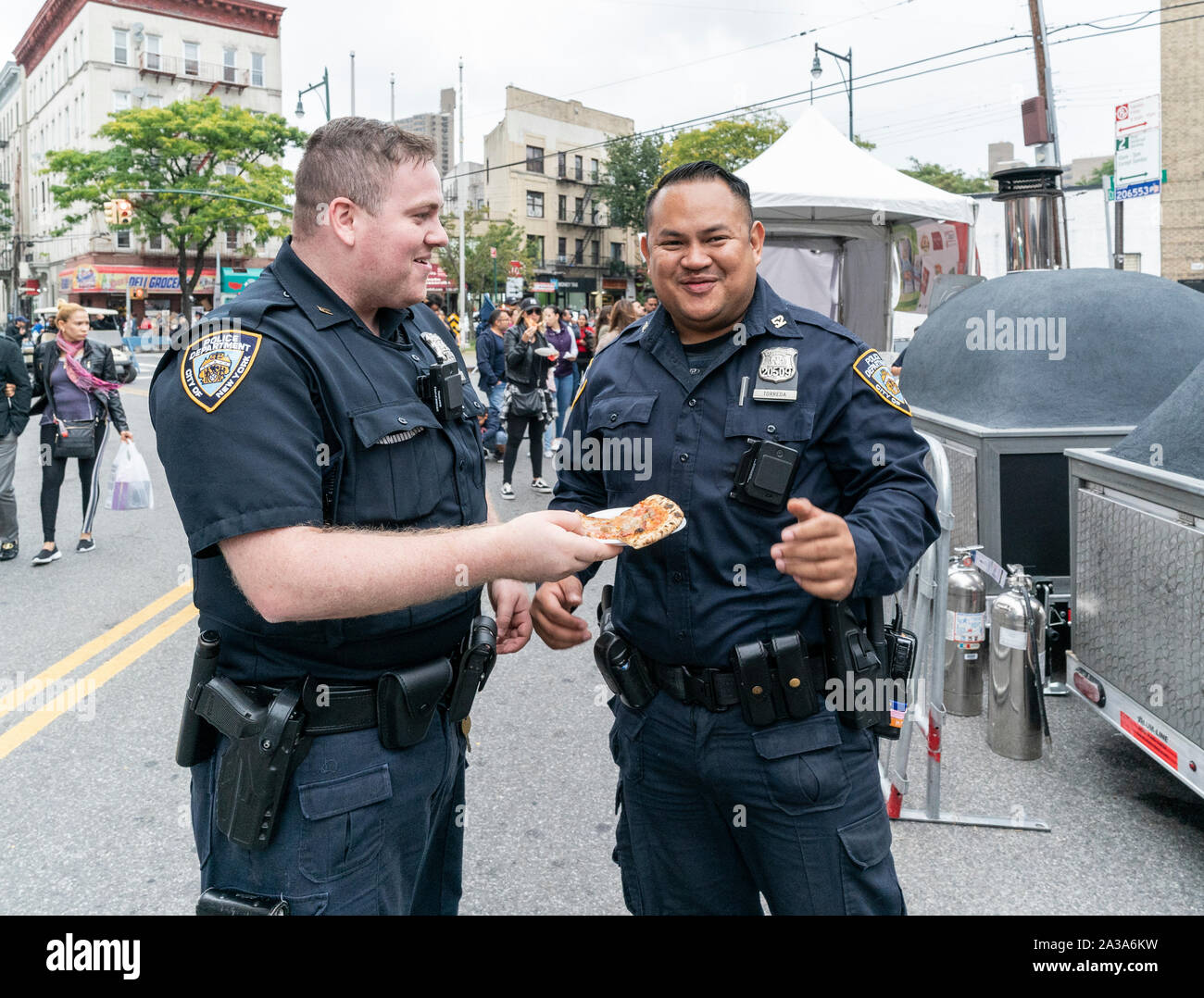 New York, NY - October 6, 2019: NYPD officers enjoy pizza slice while ...