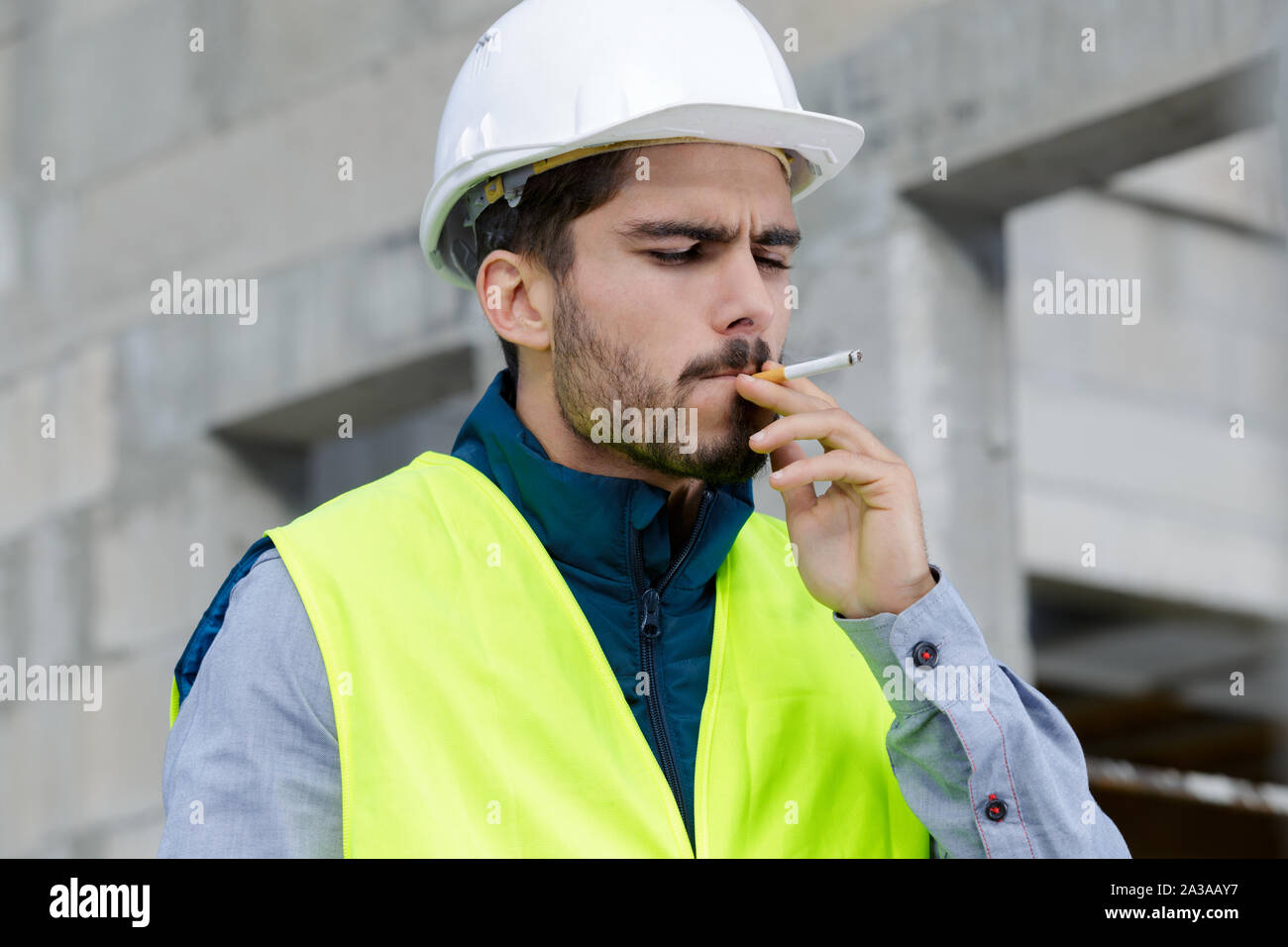 builder smoking cigarette in construction site Stock Photo - Alamy