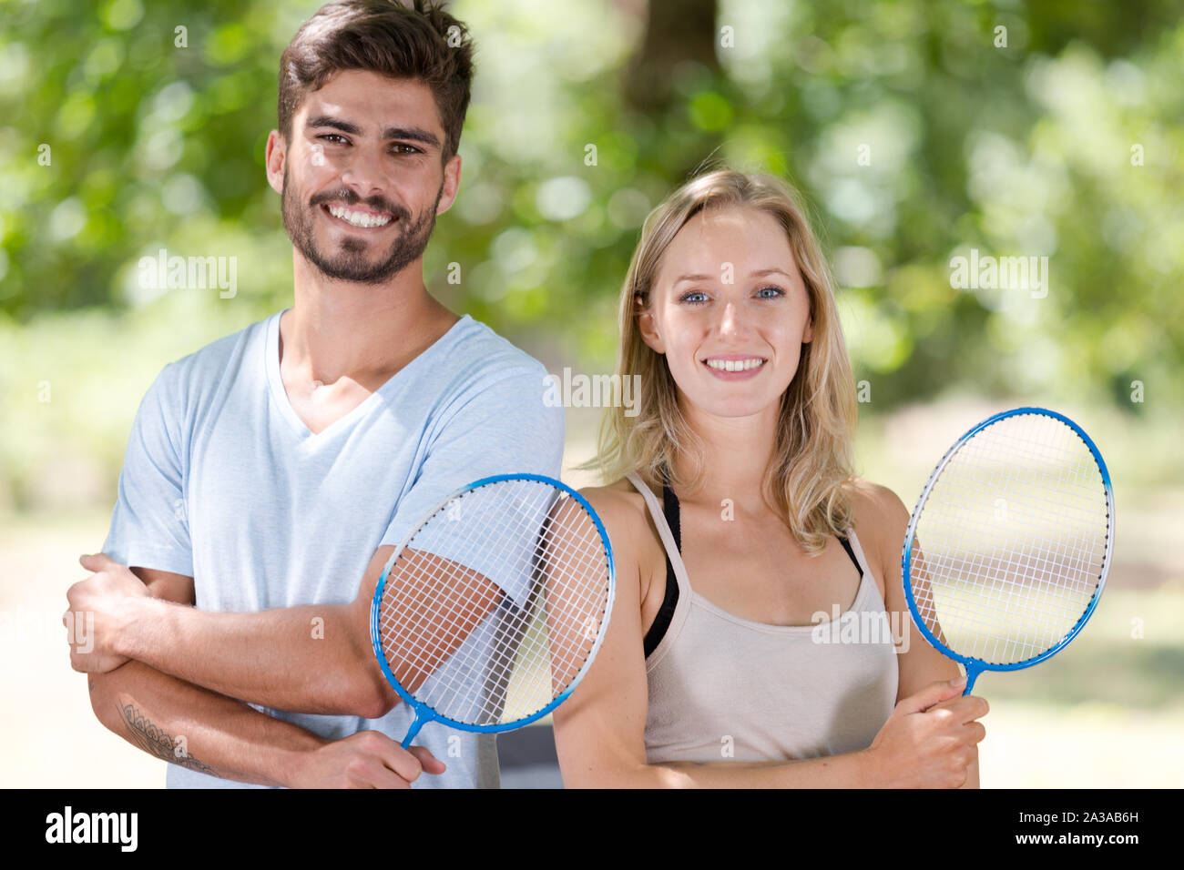 couple posing with badminton racket Stock Photo - Alamy