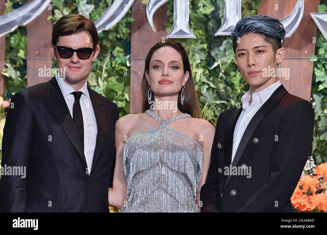 (L-R) Actor Sam Riley, actress Angelina Jolie and Japanese guitarist ...