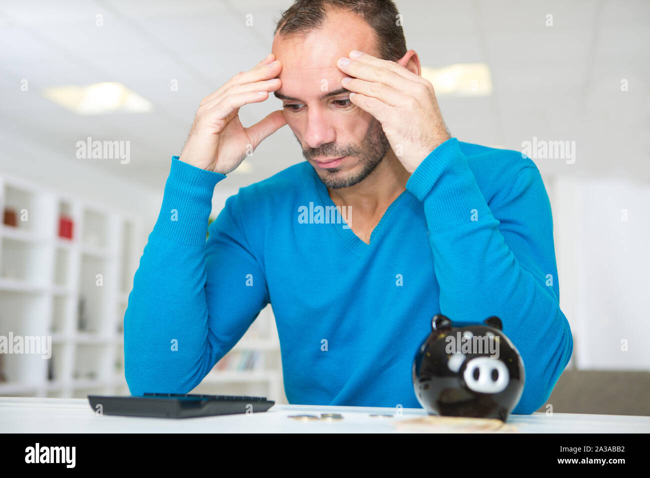 Worried business man money piggy hi-res stock photography and images ...