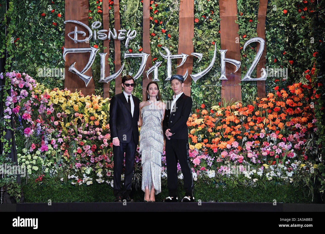 (L-R) Actor Sam Riley, actress Angelina Jolie and Japanese guitarist ...