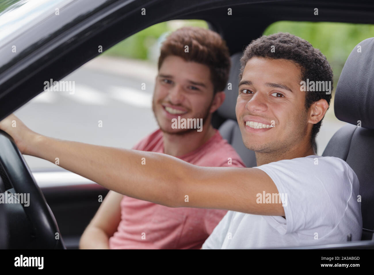 young men behind wheel of new car Stock Photo - Alamy