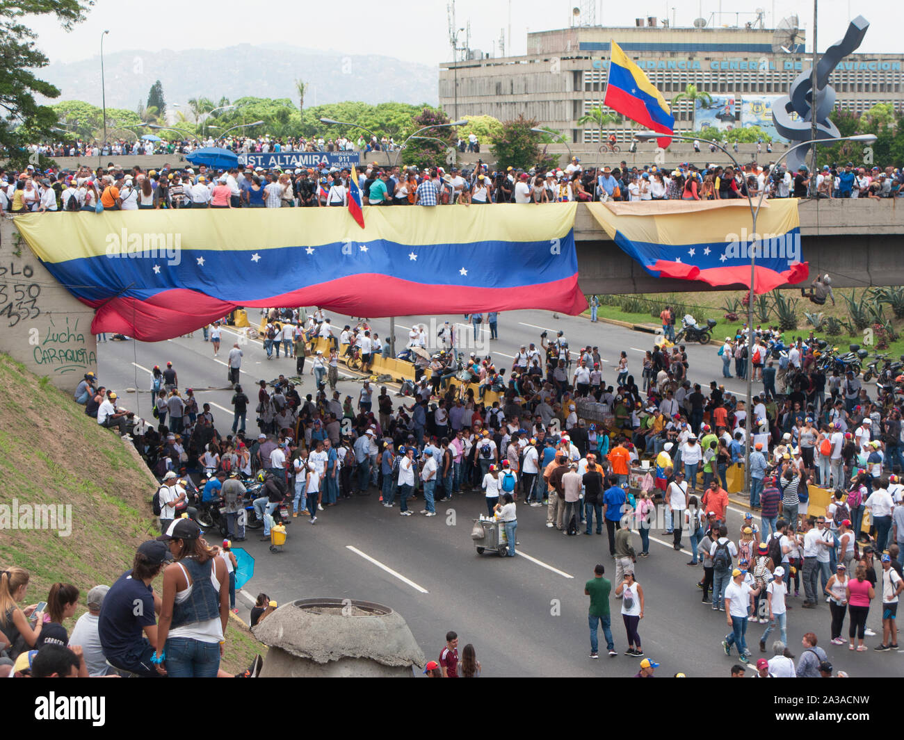 Venezuelan flags displayed and Protesters participating in the event ...