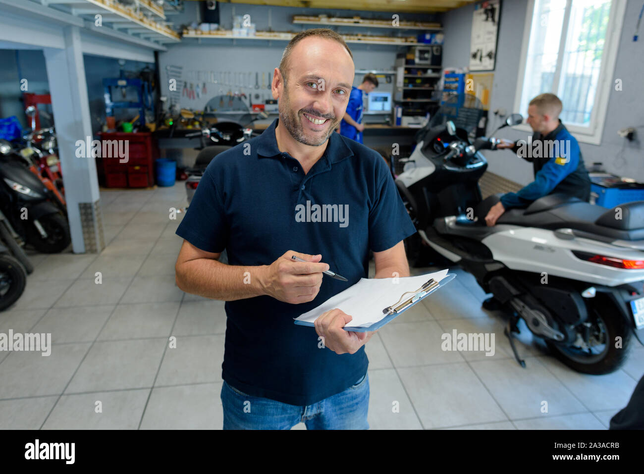 motorbike mechanical garage supervisor posing Stock Photo - Alamy