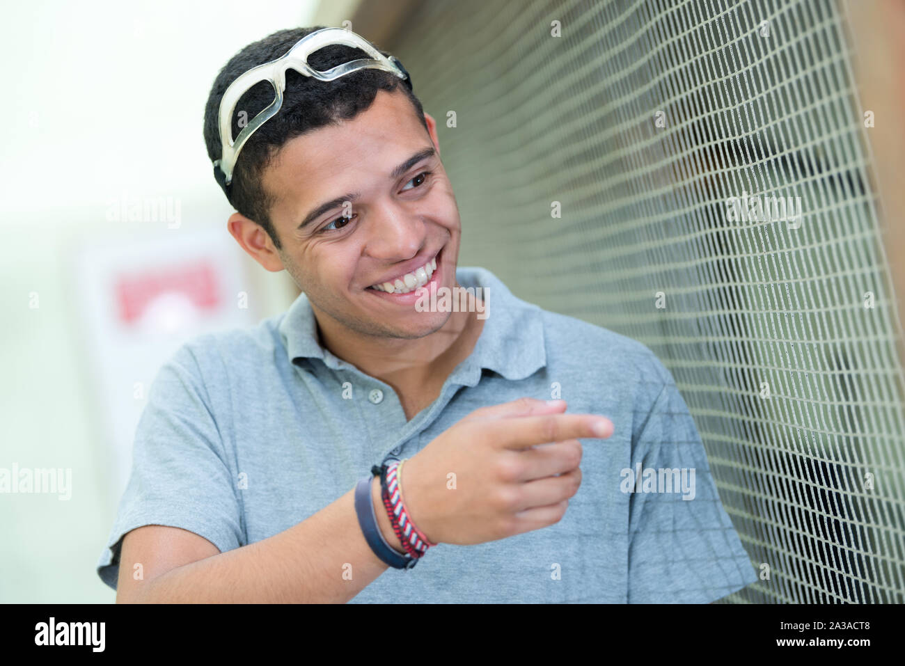 male squash player happily pointing at something Stock Photo - Alamy