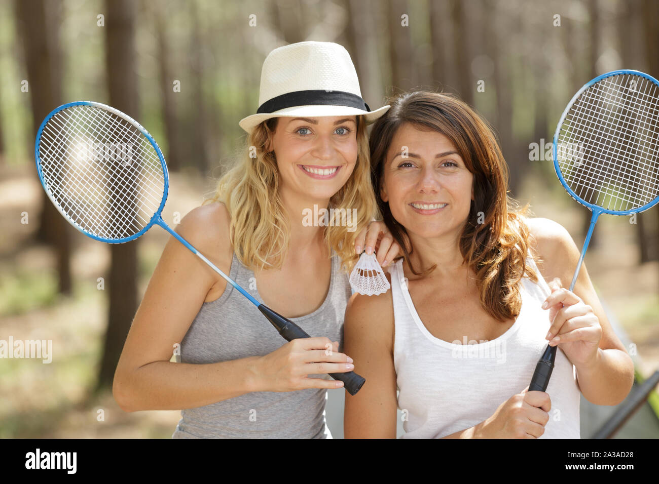 young smiling couple playing badminton in the park Stock Photo - Alamy