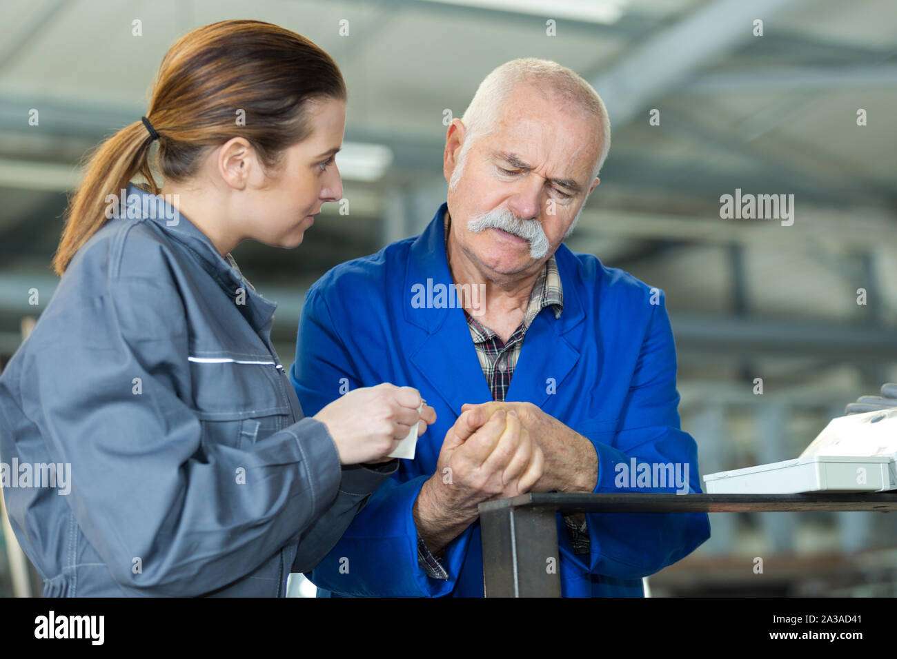 male worker and female coworker in a factory Stock Photo - Alamy