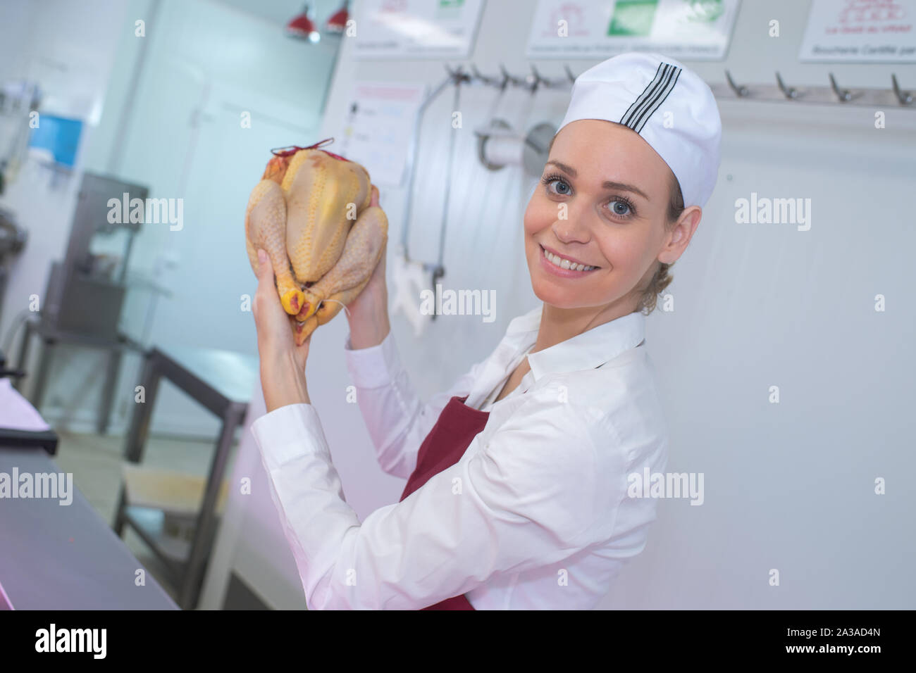 cheerful young woman wearing selling fresh chicken Stock Photo - Alamy