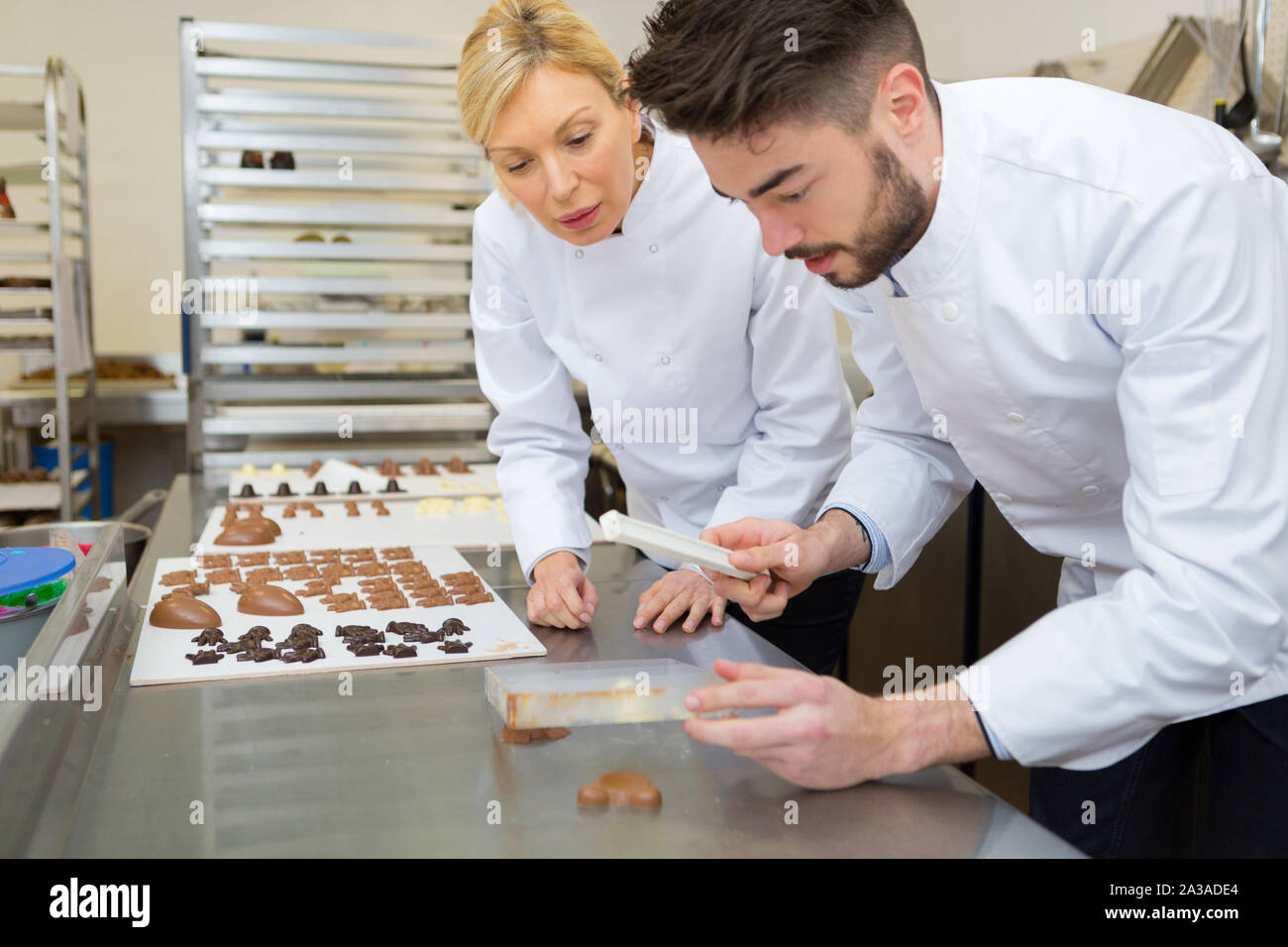portrait of workers melting chocolate Stock Photo - Alamy