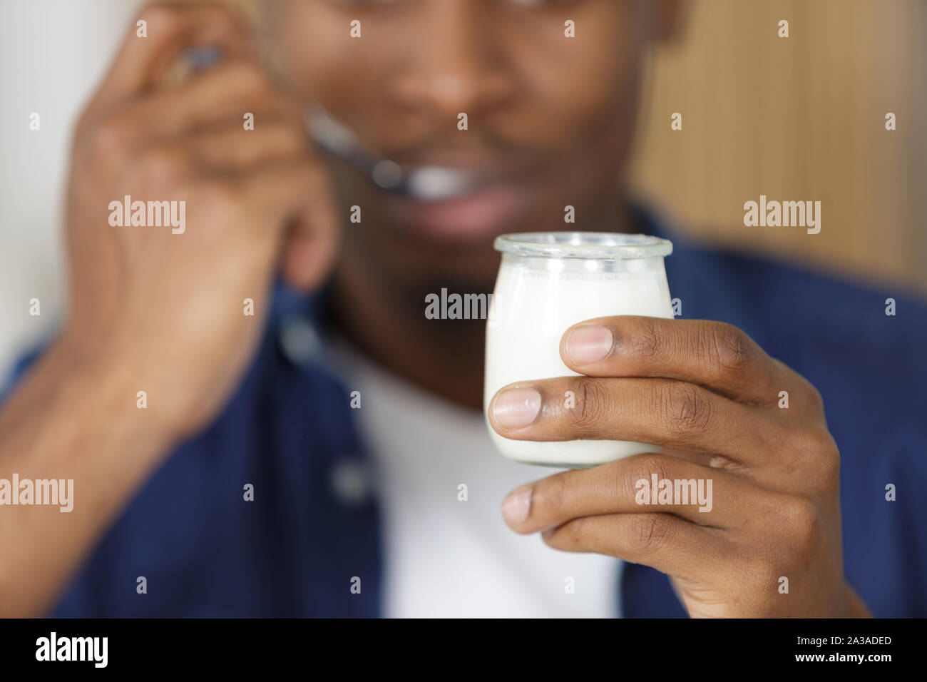 man eating natural yogurt Stock Photo - Alamy