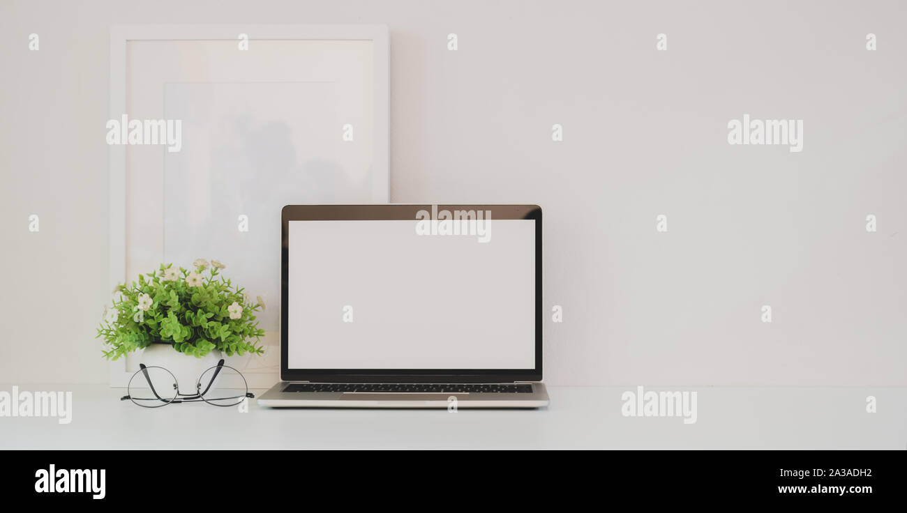 Simple workplace with minimalistic style with open blank screen laptop ...