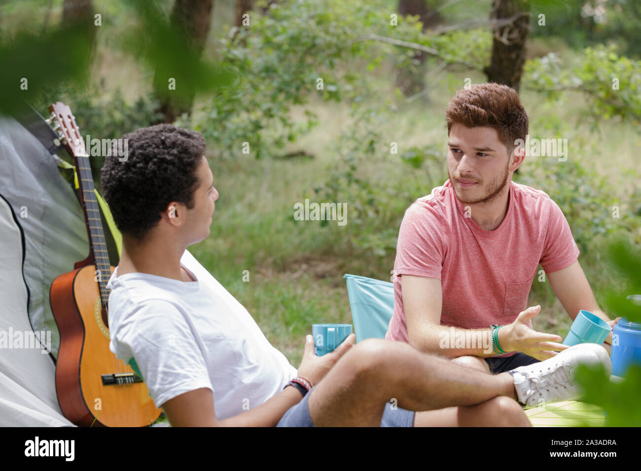 two young men are camping Stock Photo - Alamy